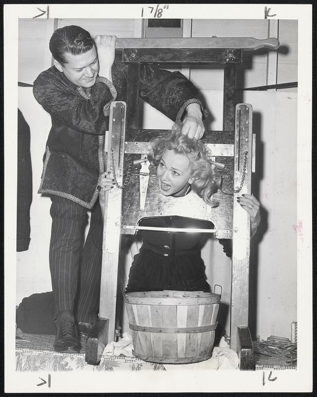 Carole Landis and Comic-Magician Russel Swann rehearse their guillotine ...