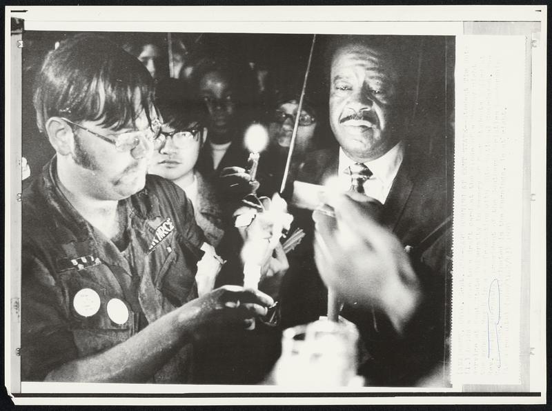 Card burning at Kent State - Student Tim Butz (L) holds a candle to a ...