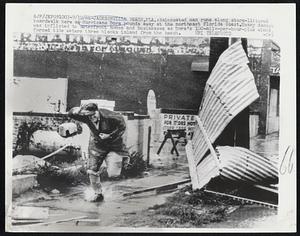 Raincoated man along storm-littered boardwalk here as Hurricane Dora ...