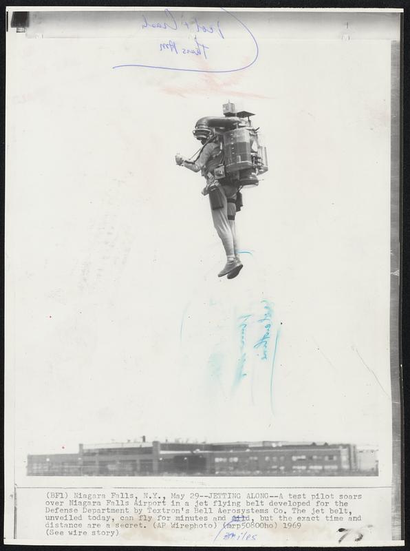 Jetting along-- A test pilot soars over Niagara Falls Airport in a jet ...