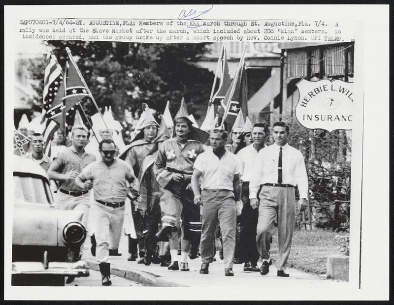 Members of the KKK march through St. Augustine, Fla. 7/4. A rally was ...