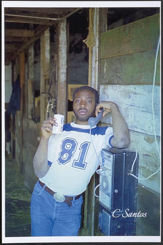 Charles Jackson on middle barn pay phone - Digital Commonwealth