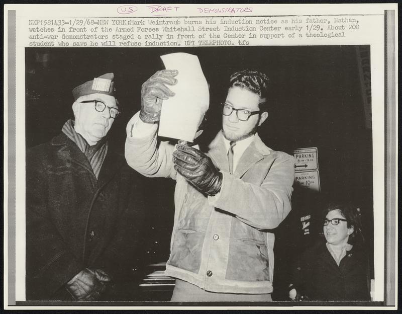Mark Weintraub burns his induction as his father, Nathan, watches in ...
