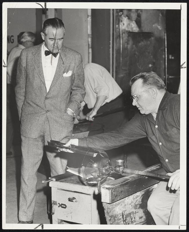 A Master Glass Blower, called a "gaffer," gives final shaping to ...