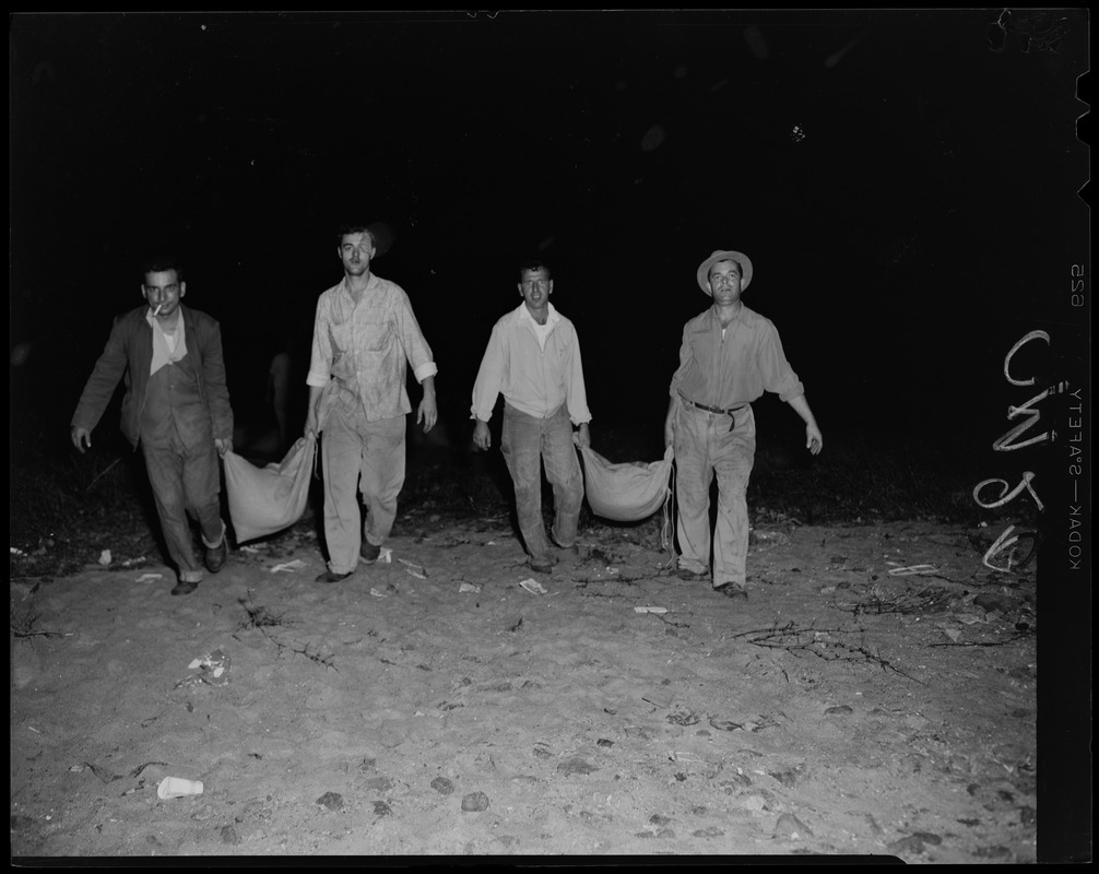 Four men carrying bags, two by two - Digital Commonwealth
