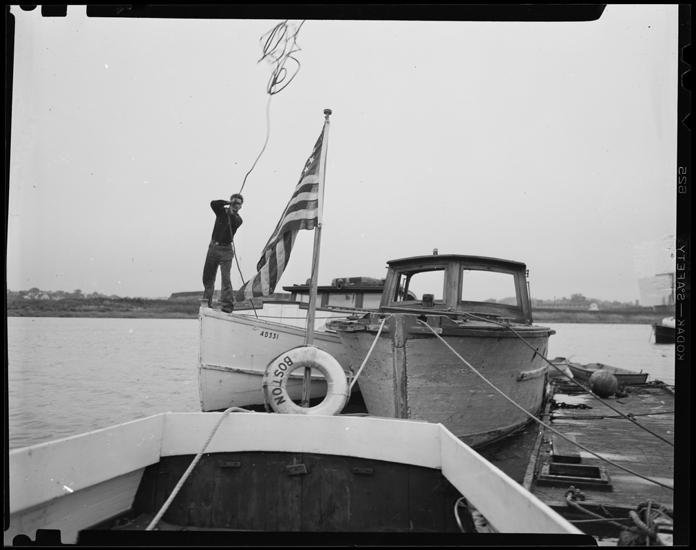 Man on boat number 4D331, throwing a rope in preparation for Hurricane ...