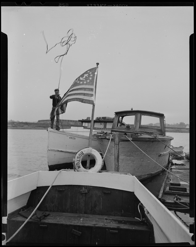 Man on boat number 4D331, throwing a rope in preparation for Hurricane ...