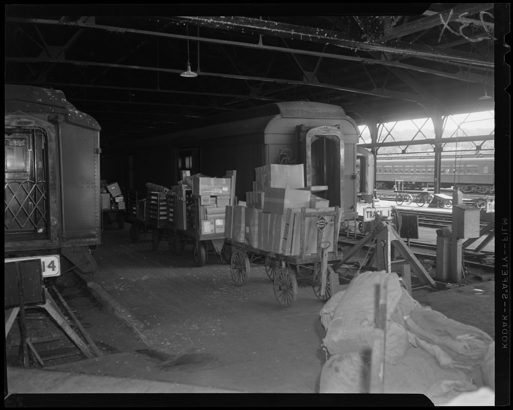 Train cars with loaded carts on platform - Digital Commonwealth