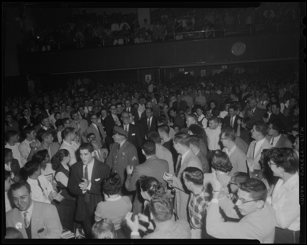 Estes Kefauver walking through large crowd gathering at an indoor event ...