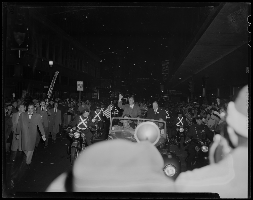 Adlai Stevenson and Paul Dever waving from car driving down parade ...