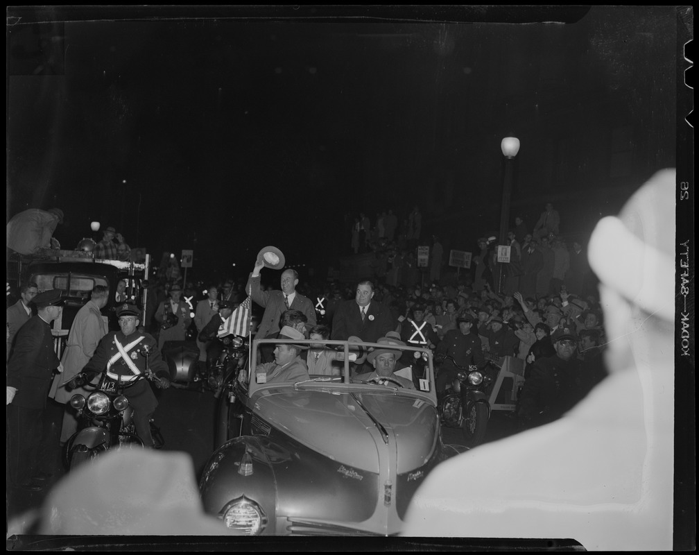 Adlai Stevenson and Paul Dever in convertible moving through parade ...