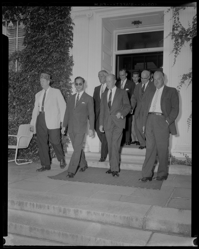 King Bhumibol Adulyadej and other men exiting a building - Digital ...