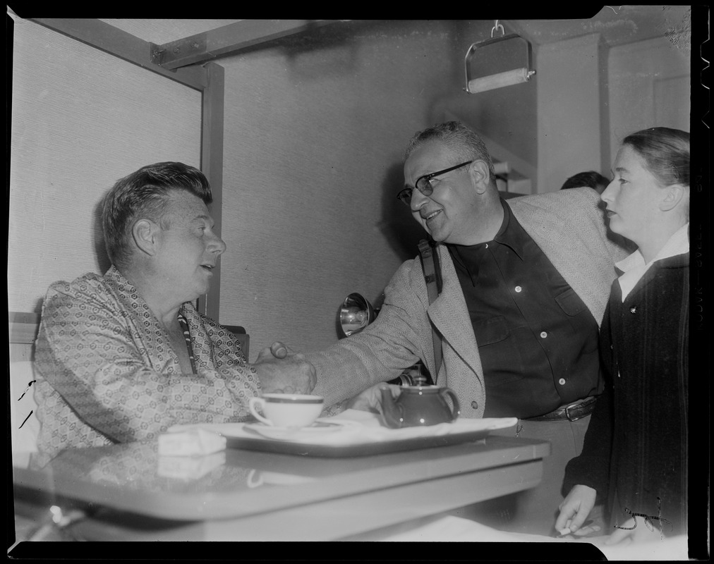 Arthur Godfrey shaking hands with another man - Digital Commonwealth