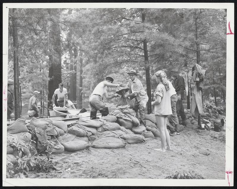 Sandbags are stacked along Turtle lane, Dover, to hold back rising ...