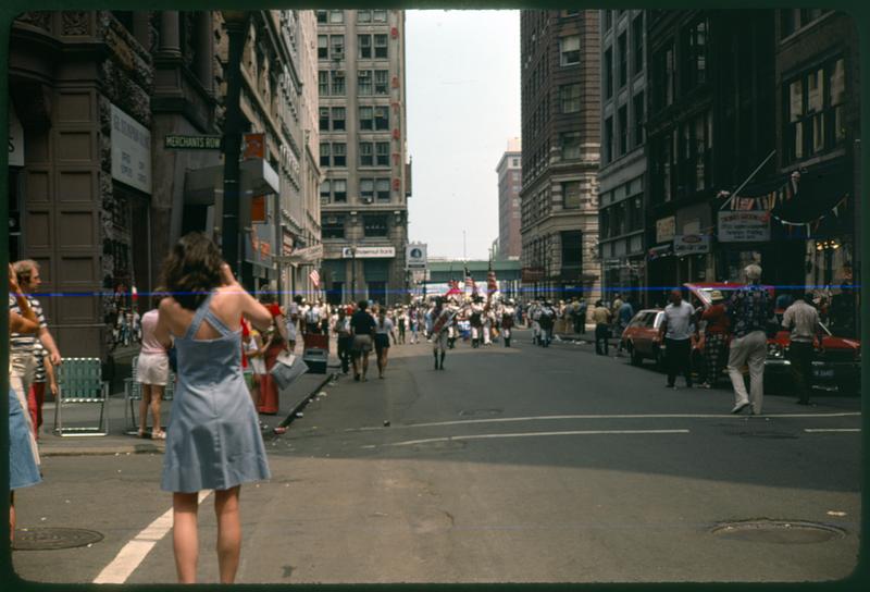 Spectators watching a parade of people in colonial dress, Merchants Row ...
