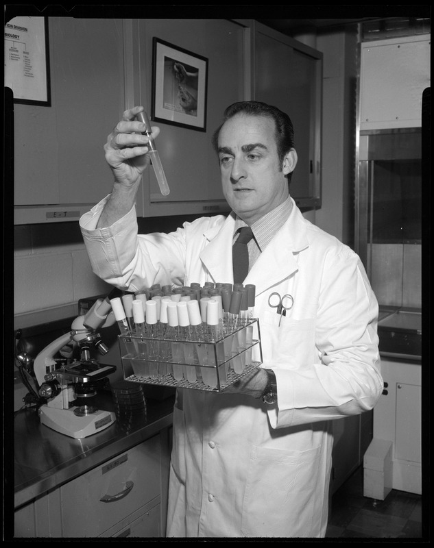FSL, Ed Powers, checking out test tubes in lab - Digital Commonwealth