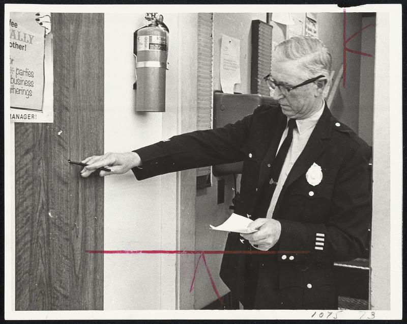 Stow Police Chief Winthrop Addy points to bullet hole in wall at Purity ...
