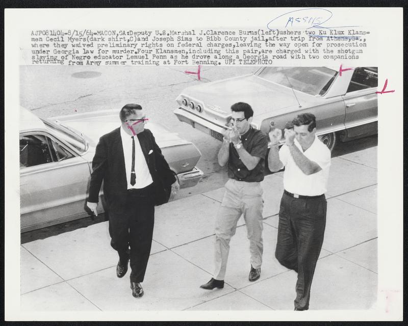 Deputy U.S. Marshal J. Clarence Burns (left) ushers two Ku Klux ...
