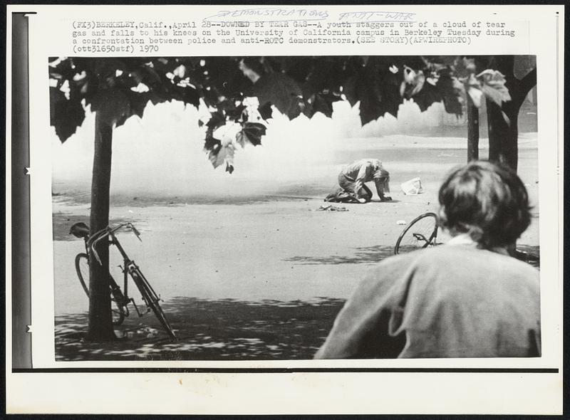 Berkeley, Calif. -- Downed By Tear Gas -- A youth staggers out of a ...