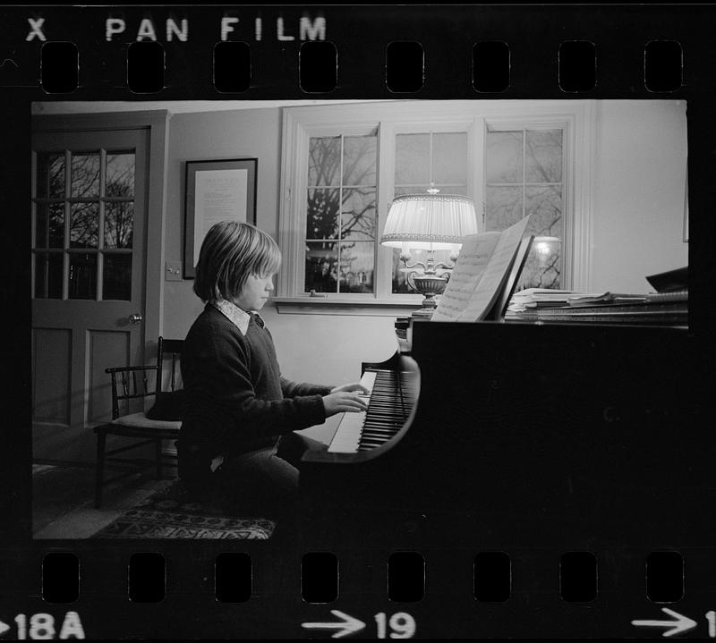 Bruce Irving's child playing the piano - Digital Commonwealth
