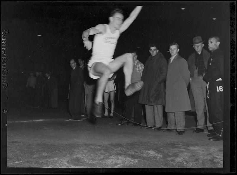 Indoor track, Bob Whitham doing long jump - Digital Commonwealth
