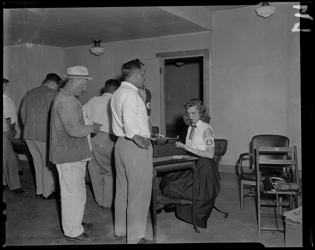 Woman with Worcester Warden Division arm band seated at typewriter ...
