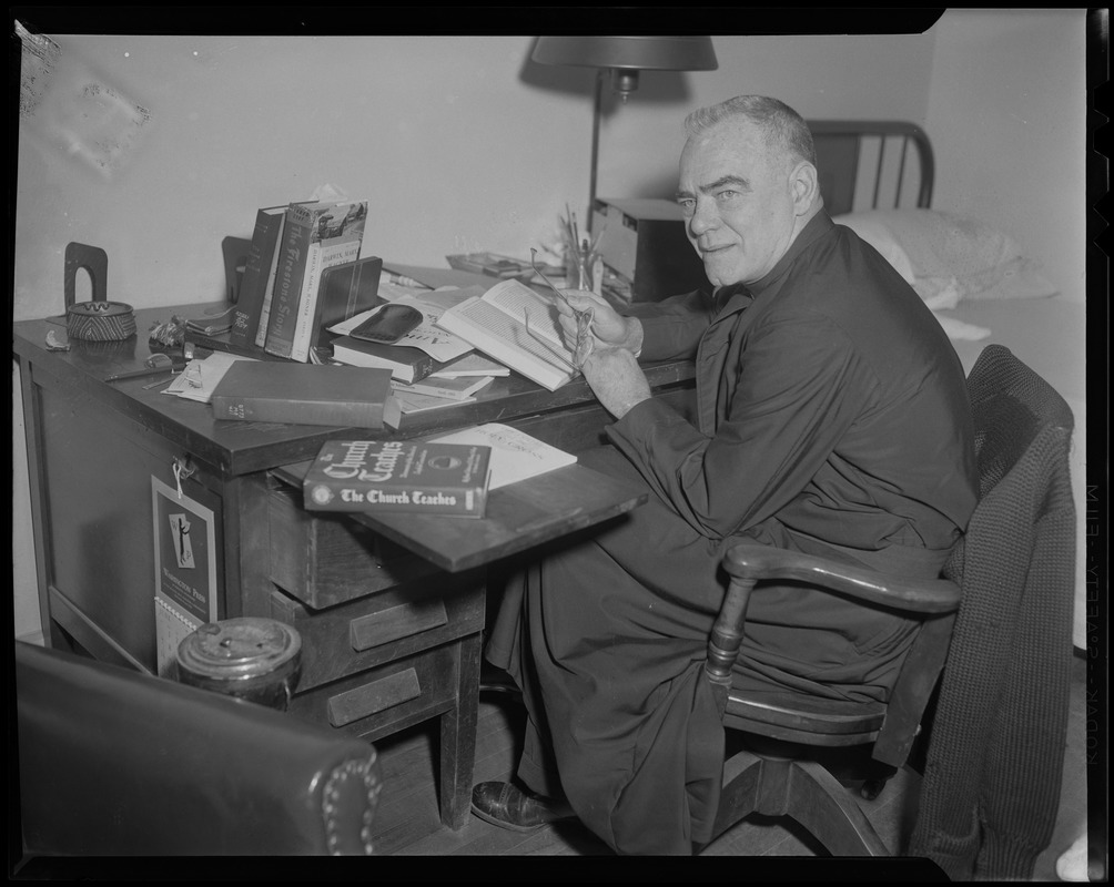Fr. Joseph T. O'Callahan seated at desk, holding glasses - Digital ...