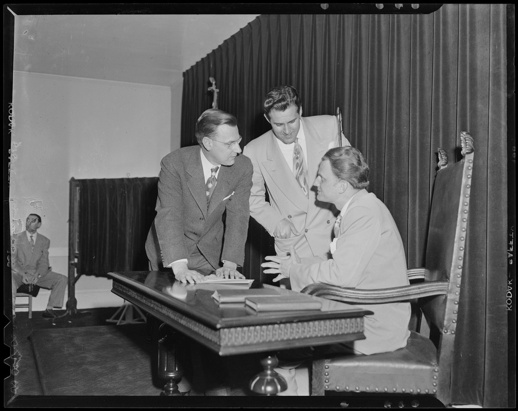Billy Graham seated, in discussion with two men - Digital Commonwealth