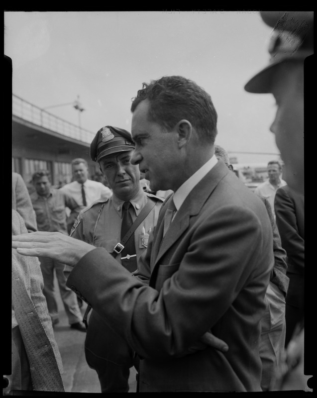Vice President Richard Nixon talking, with police officer looking on ...