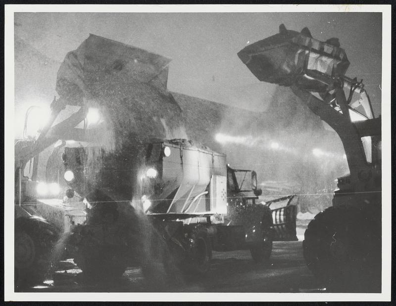 Weather storms snow. Rock salt, going into night, - two loaders ...