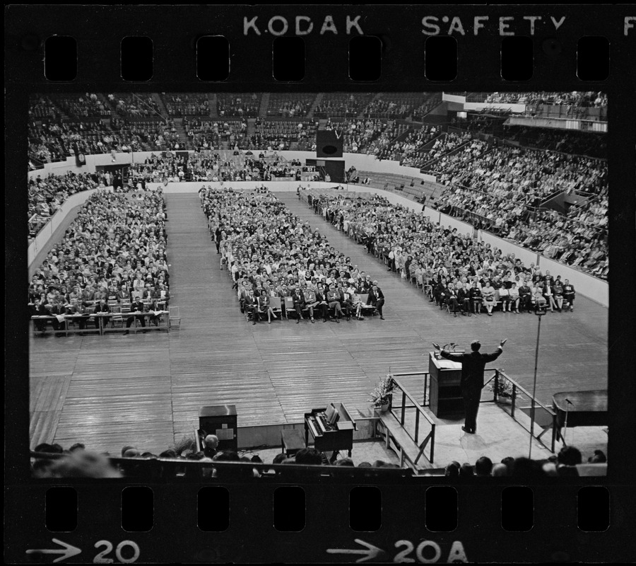 Billy Graham speaking at Boston Garden, crowd in front of him in three ...