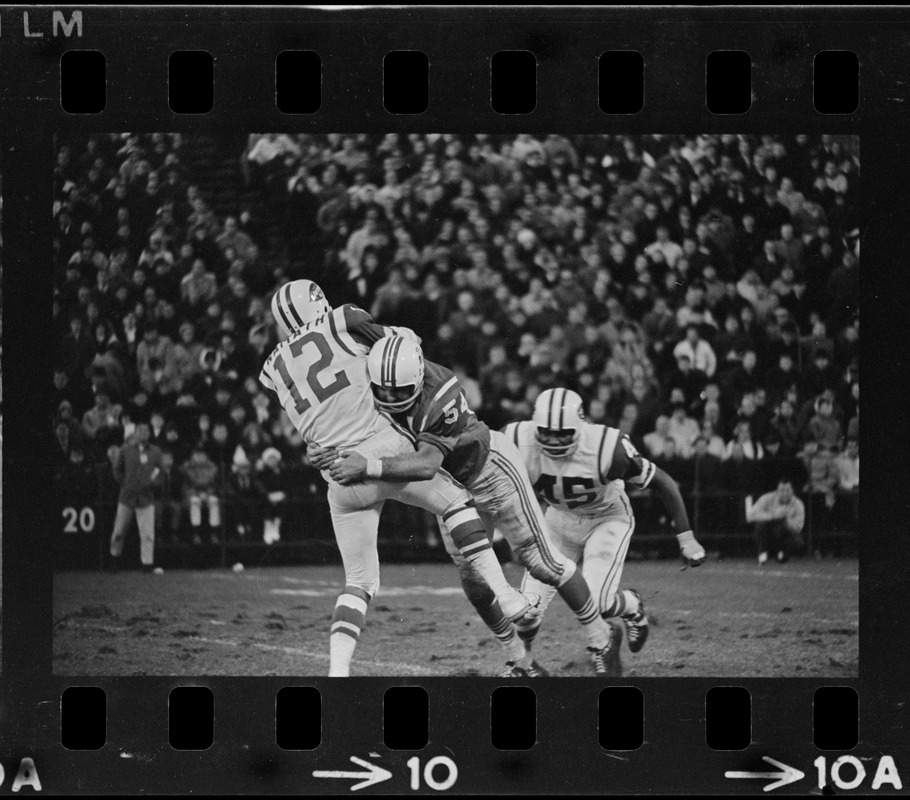 New England Patriot tackling a New York Jet player in a football game ...