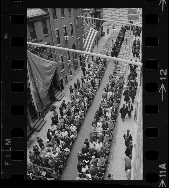 Narrow rows of seats at Suffolk University graduation with procession ...