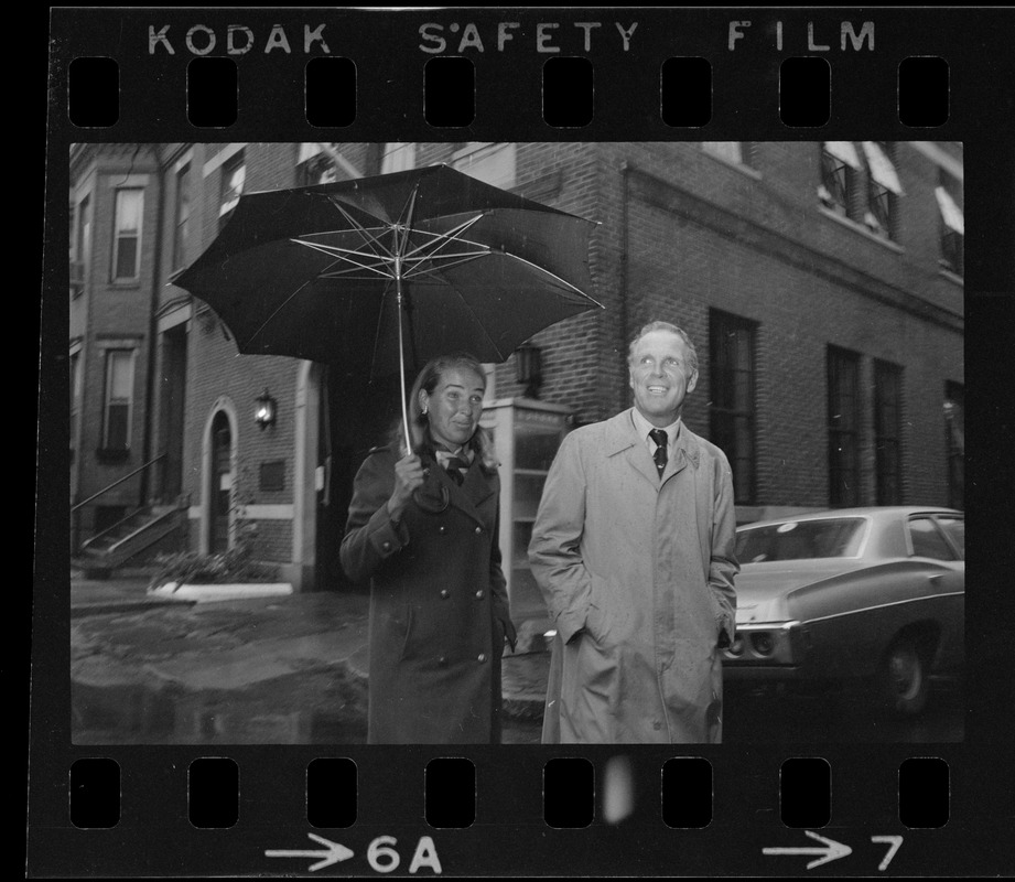 Boston Mayor Kevin White and Kathryn White walking through rain to vote ...