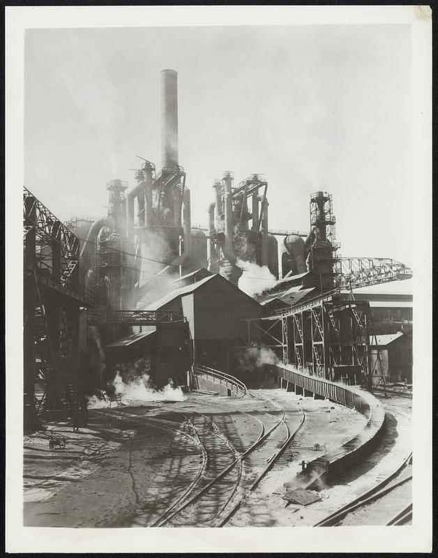 Today's modern furnaces tower more that 100 feet in the air, produce ...