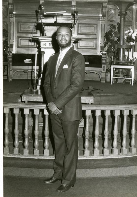 St. Paul AME, Ken Reeves standing in front of pulpit, Oct. 1983 ...