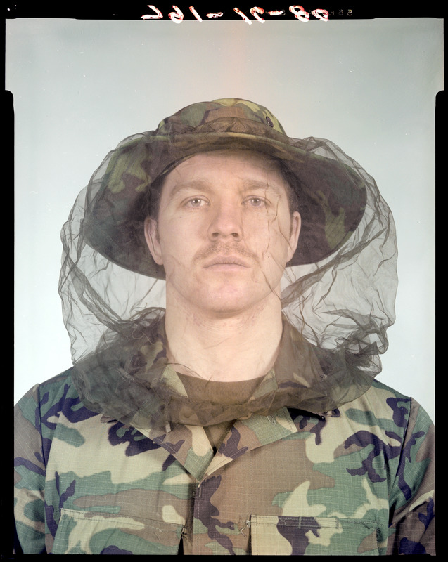 Camouflage uniform and hat with insect net - Digital Commonwealth