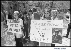Local resident (an older woman) holds up a sign reading 'Seabrook voted ...