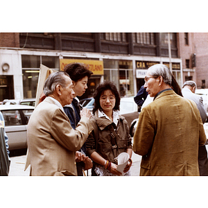 Five people on the corner of Beach Street and Harrison Avenue collect ...