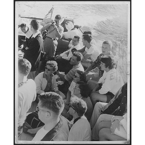 Men and women seated inside boat - Digital Commonwealth