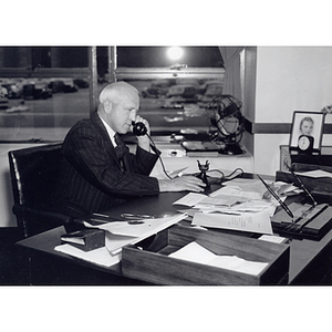 President Carl S. Ell on the phone in his office - Digital Commonwealth