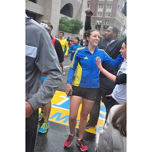 Runners smile and celebrate at the One Run finish line - Digital ...