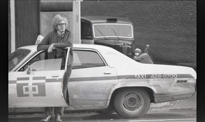 Taxi cab driver standing by his cab - Digital Commonwealth