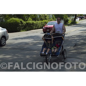 Runner with baby carriage at the StonehamStrong 5K - Digital Commonwealth
