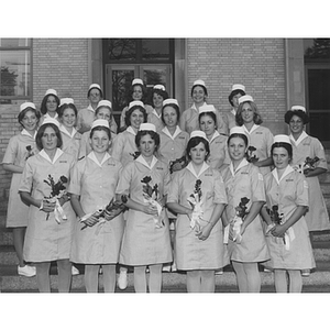 College of Nursing graduation class with roses - Digital Commonwealth