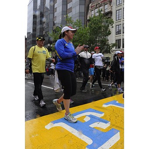 Numerous "One Run" participants approach the Copley Square finish line ...