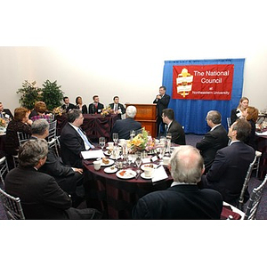 Seated guests listen to a speaker at The National Council Dinner ...