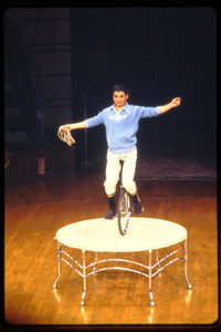 Shanghai acrobats: man on a unicycle balancing on a table - Digital ...