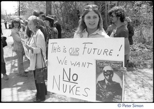 Community protester holding sign reading 'This is out future! We want ...