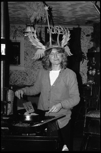 Janice Frey at the stove, making a silly face, wearing a winged No ...
